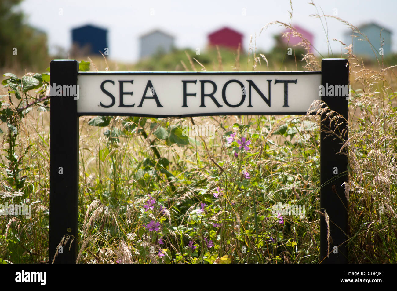 Sea Front street sign with beach huts in the background, SSSI meadow ...