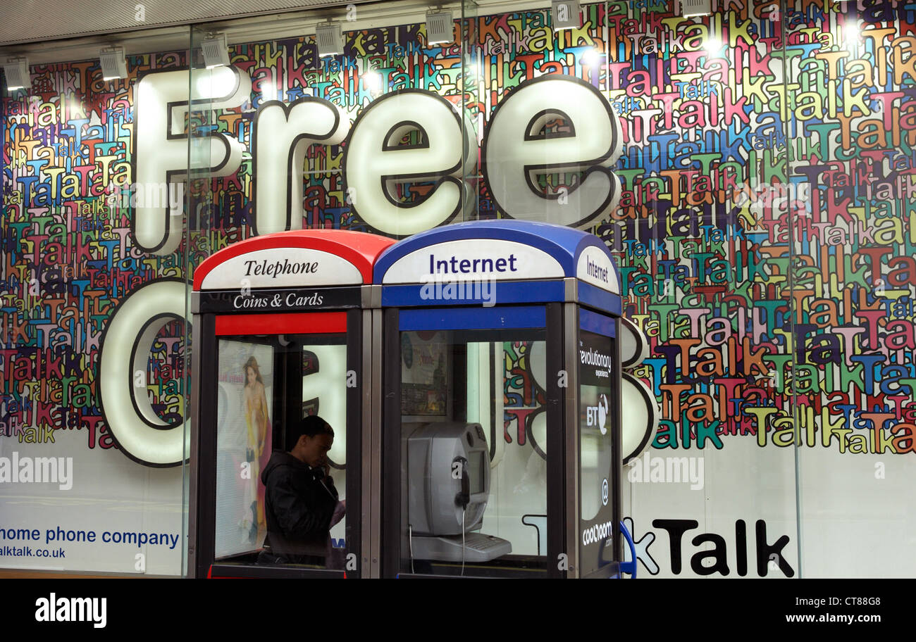 London - telephone booths in front of a telephone advertising Stock ...