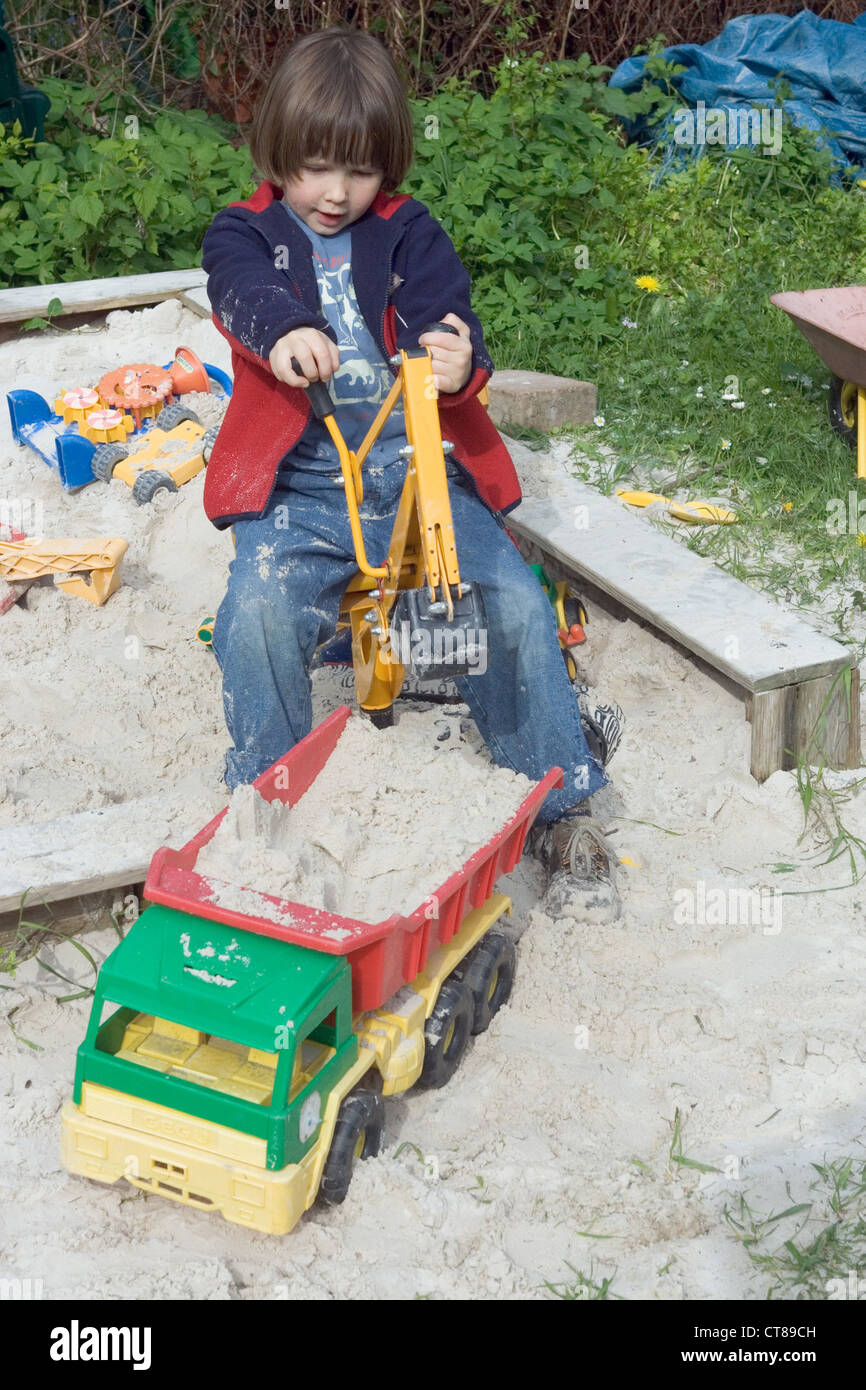 A child playing in the sandbox Stock Photo - Alamy