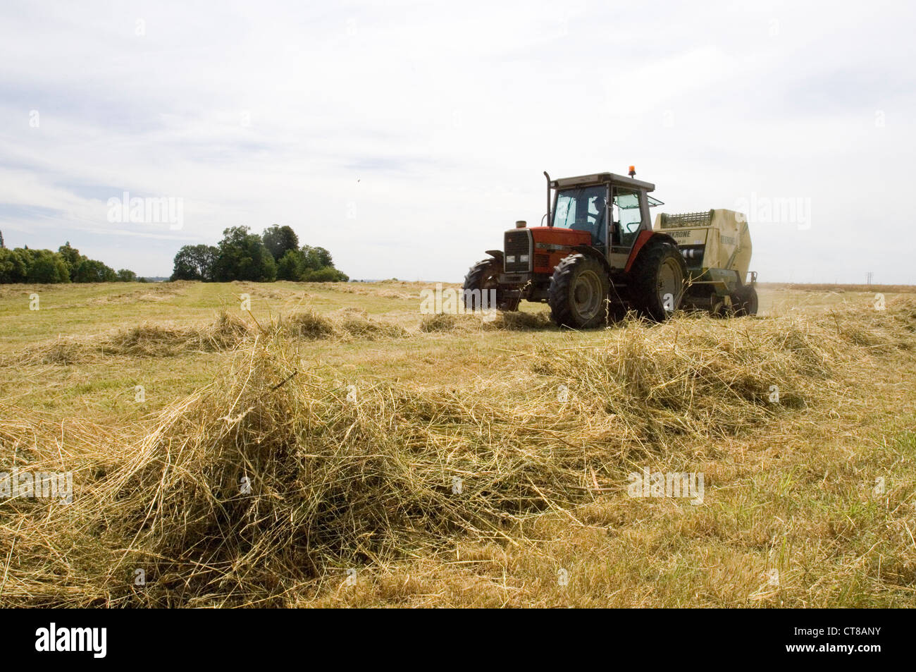 Tractor during hay making in Oxfordshire field Stock Photo - Alamy