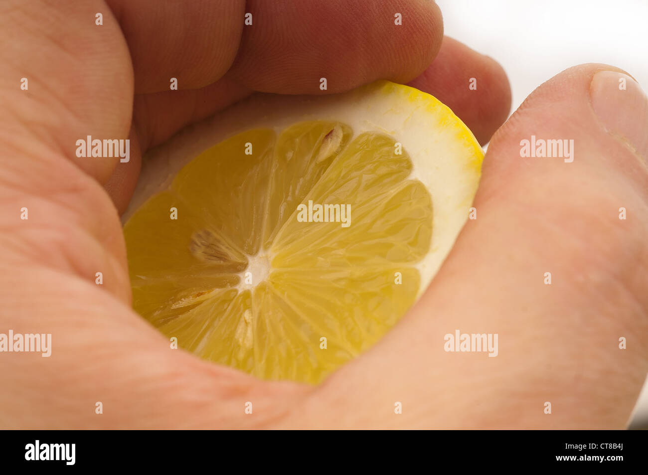 fresh ripe lemon cutted in half hold in hand closedup Stock Photo - Alamy