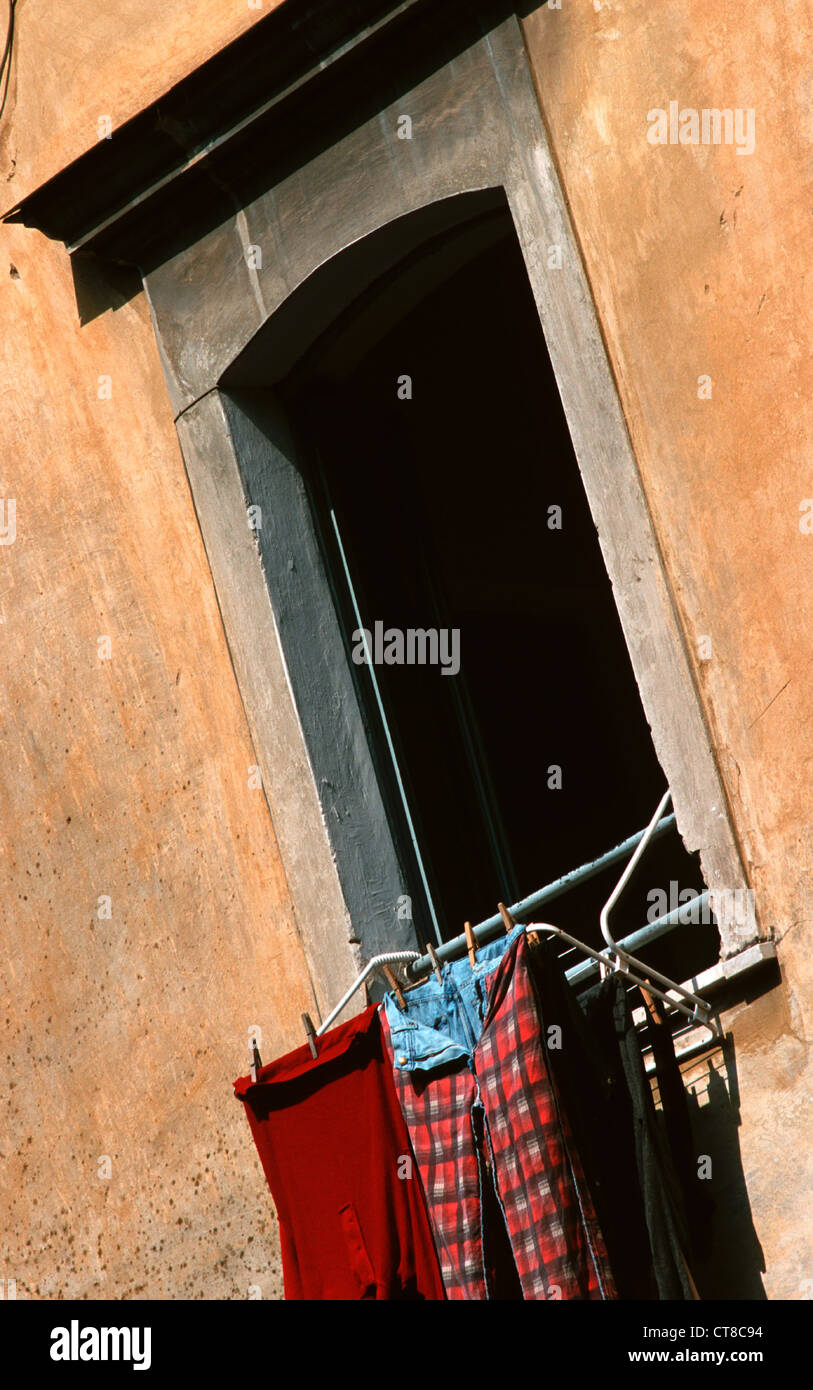 Laundry drying on the window of an old house Stock Photo - Alamy