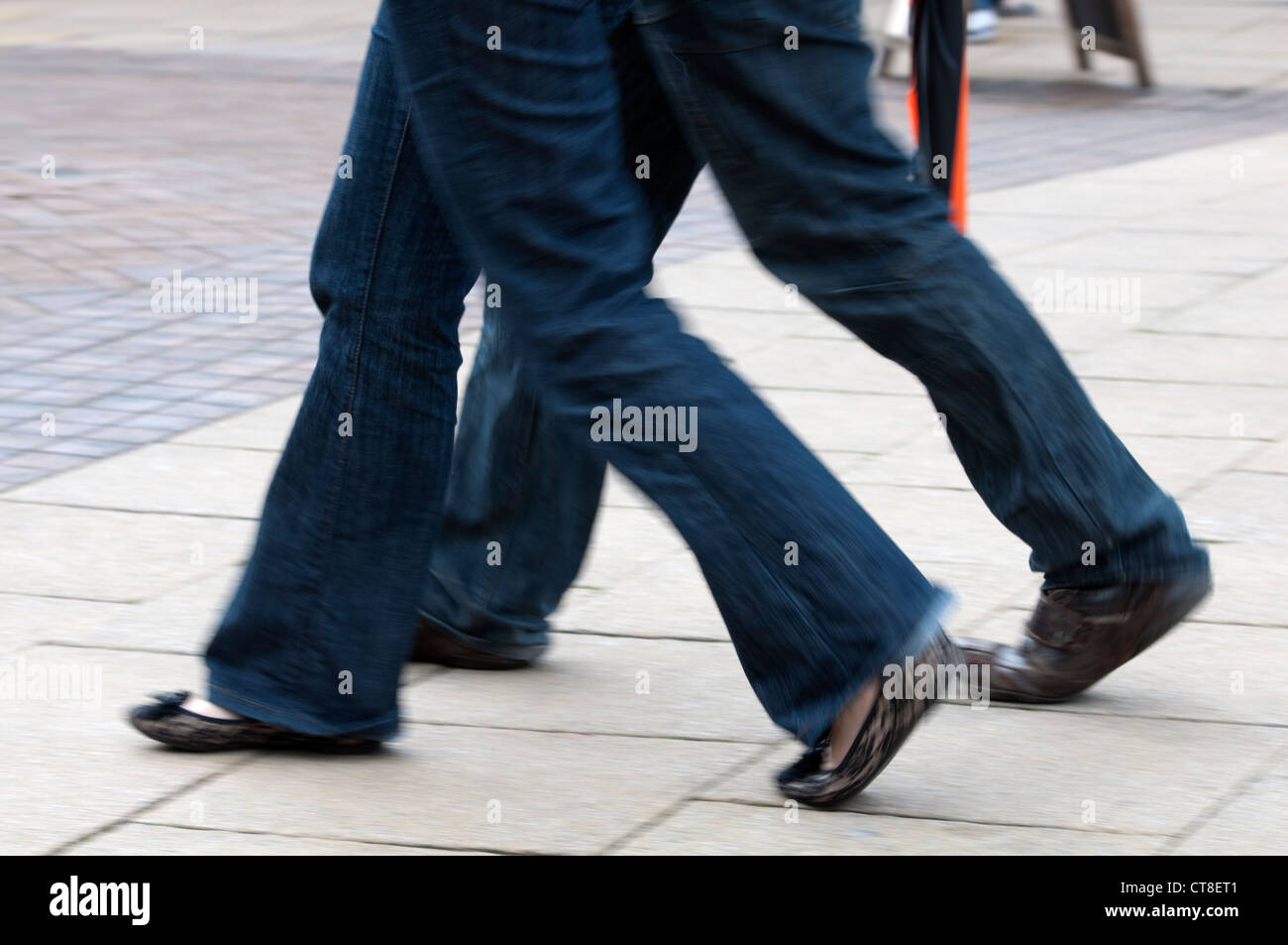 A man and a woman walking in step Stock Photo - Alamy