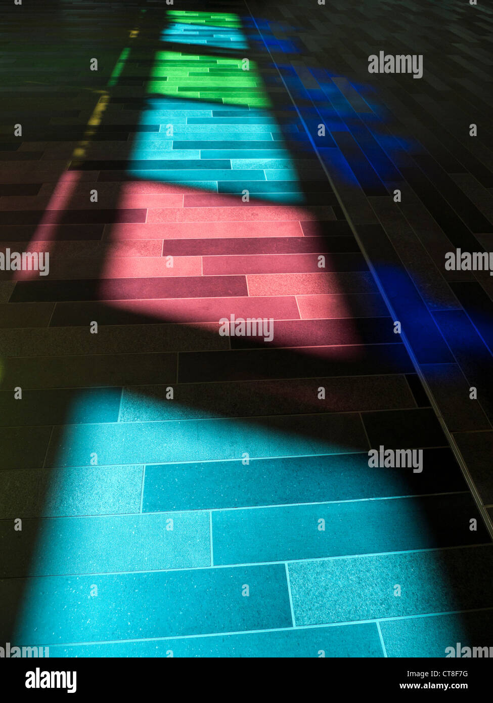 Coloured light cast by tinted windows onto floor of Palais des congres ...