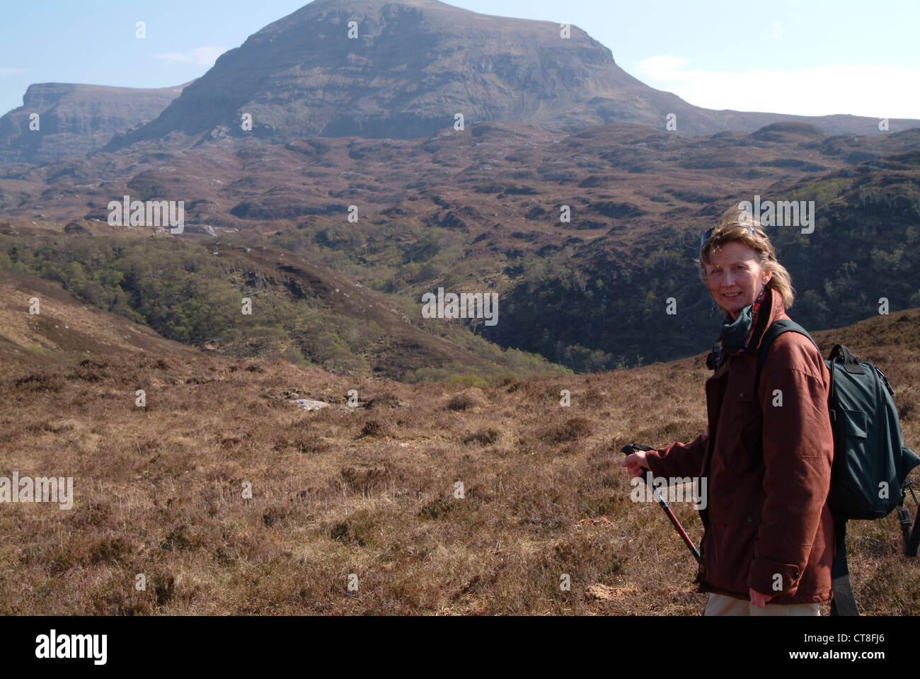 Woman hillwalking alone in spectacular countryside, Sutherland ...