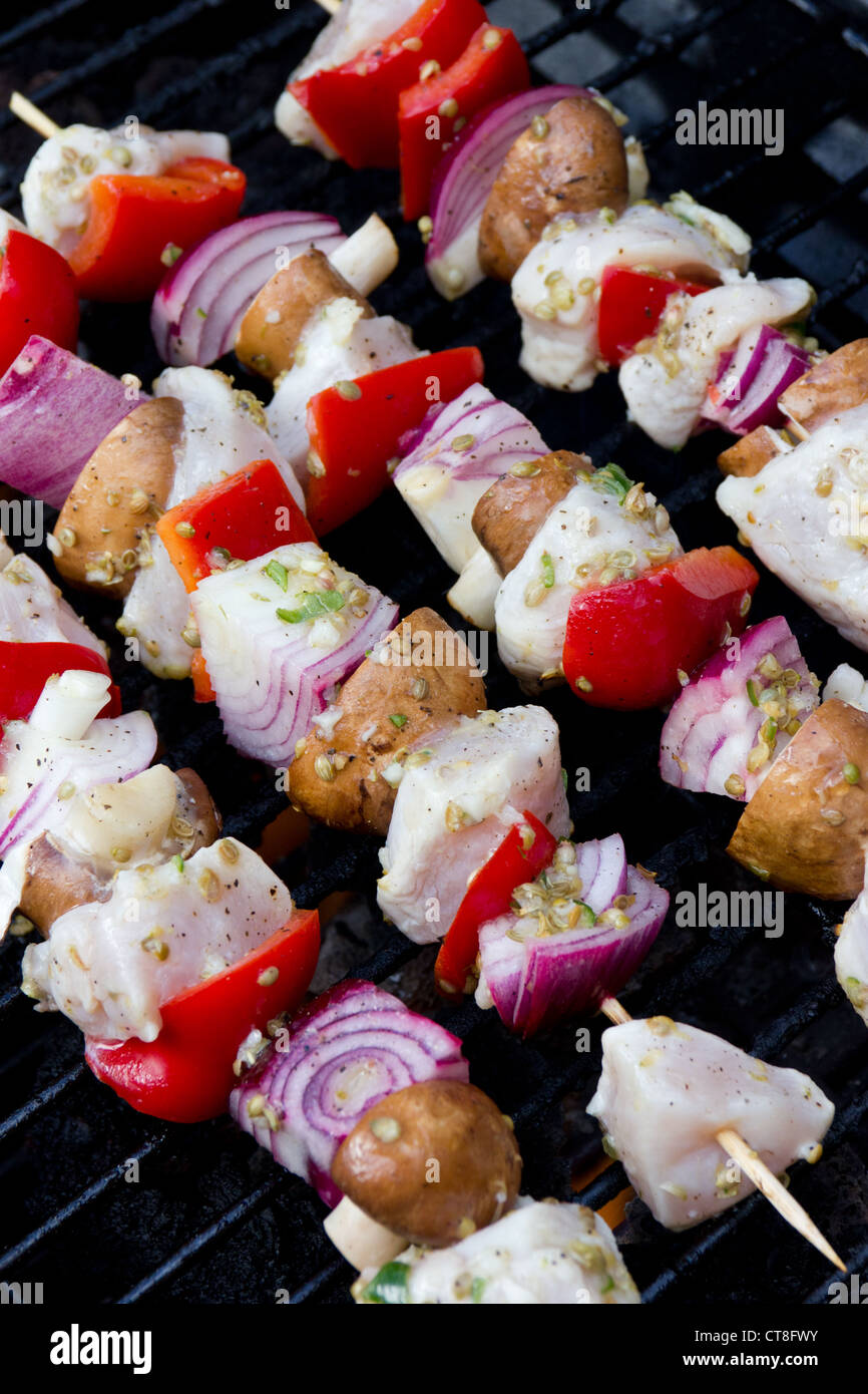 uncooked marinated chicken and vegetable kebabs on a barbecue Stock ...