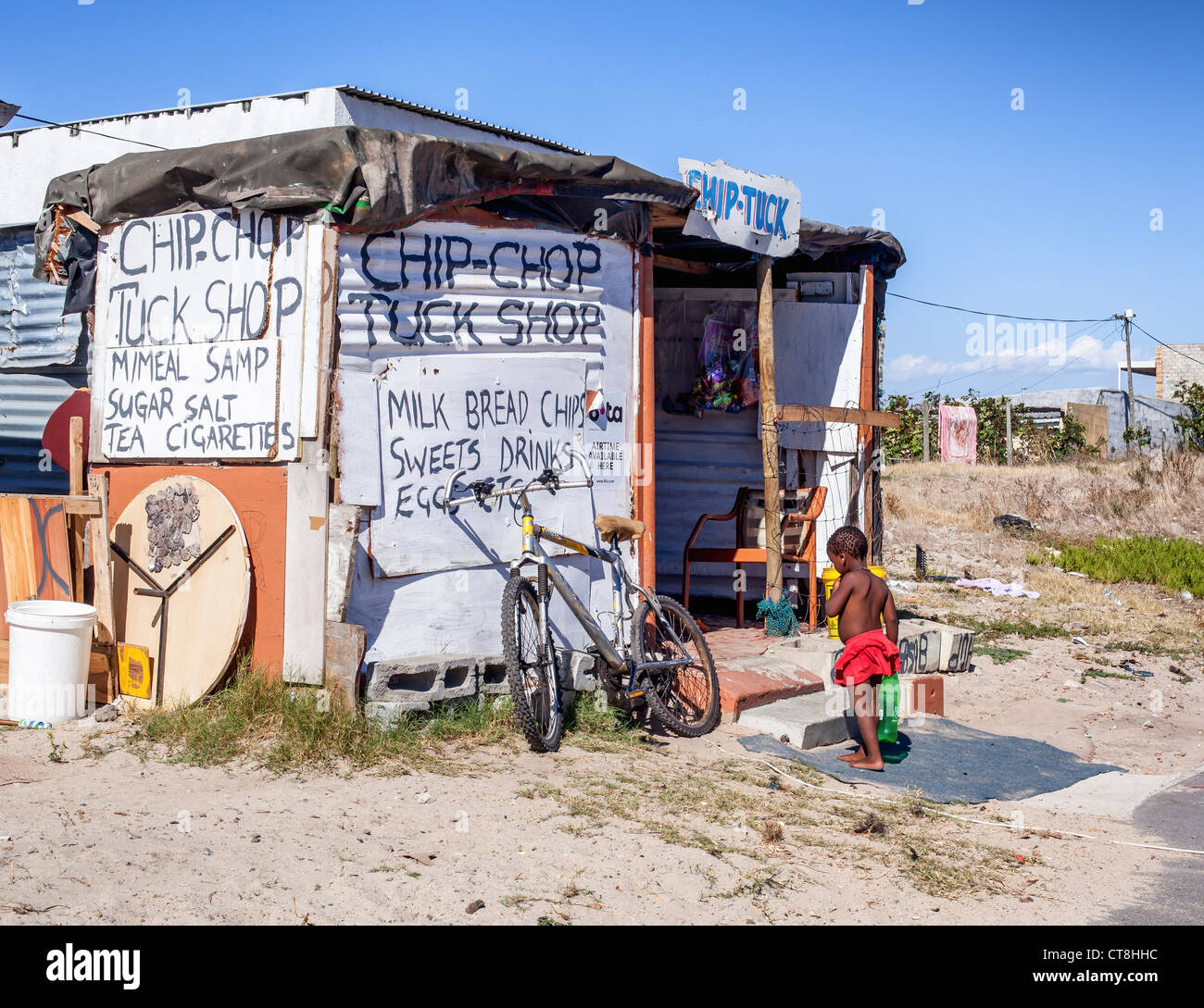 A young child visits a tuck shop (spaza) in Langa African Township near ...