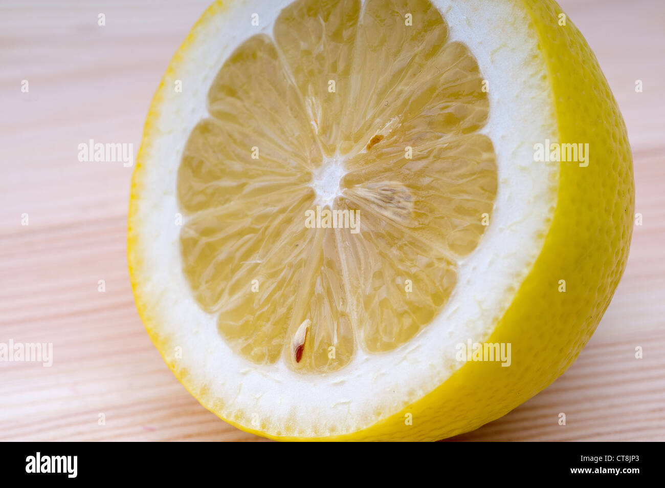 fresh ripe lemon cutted in half closedup over wood table Stock Photo ...