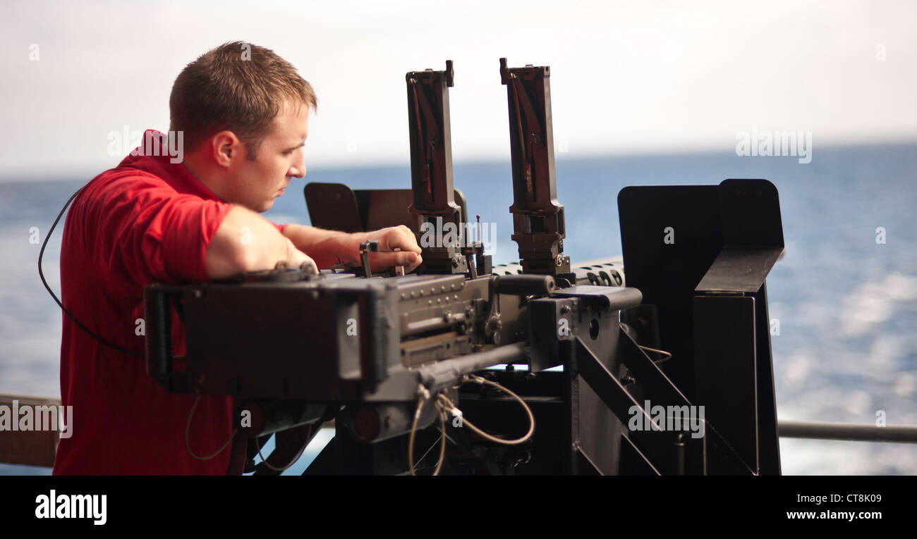 Aviation Ordnanceman 3rd Class Scott Segel sets up dual .50-caliber ...