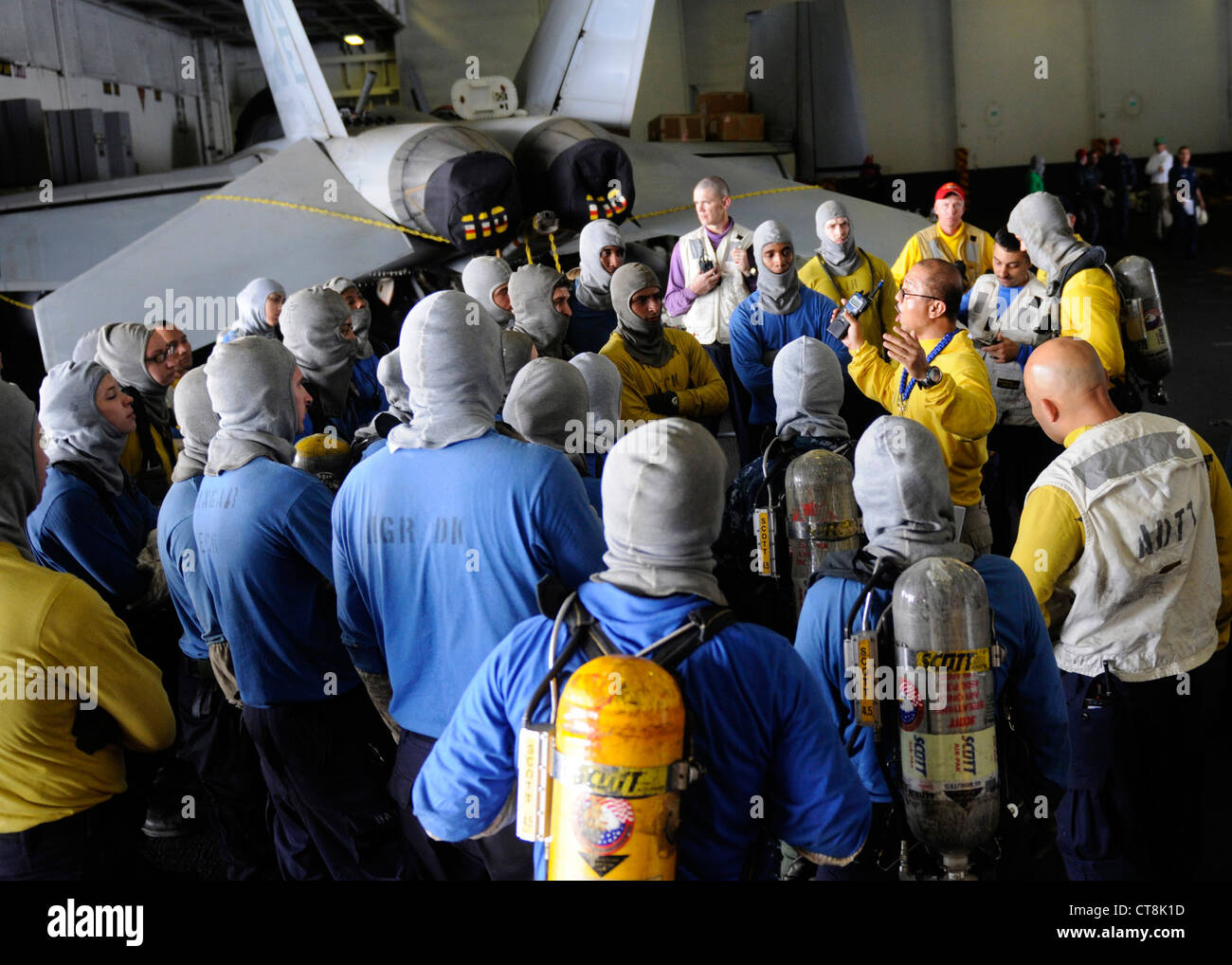 Sailors gather in the hangar bay of the Nimitz-class aircraft carrier ...