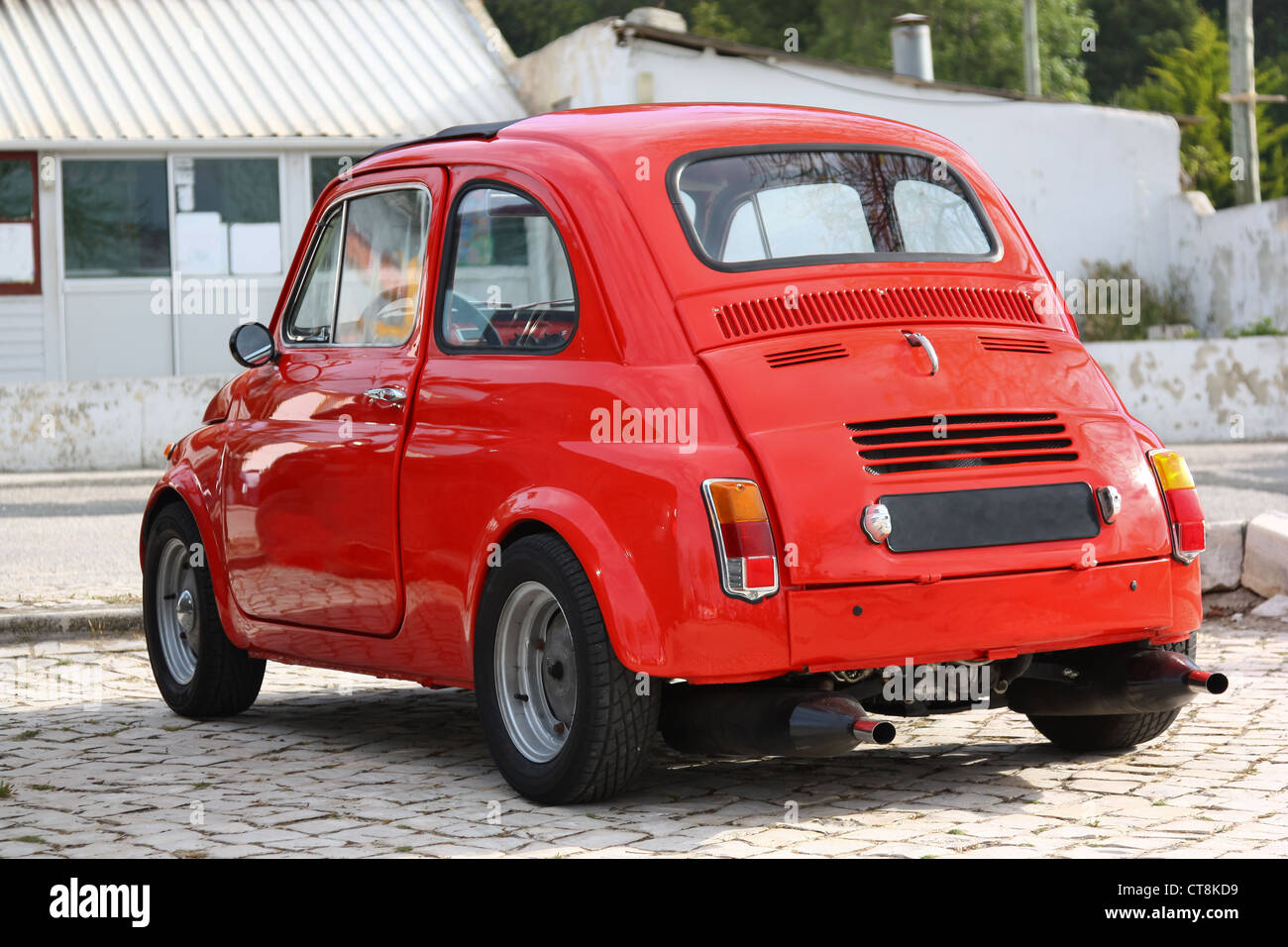 Rear view of an small classic red car Stock Photo - Alamy