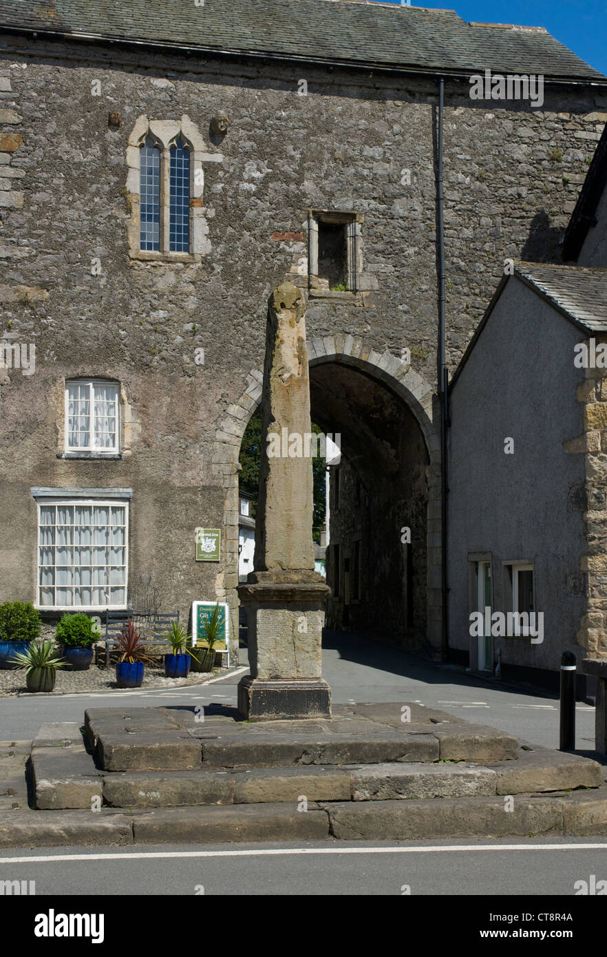 The gatehouse and market cross in the village of Cartmel, South ...