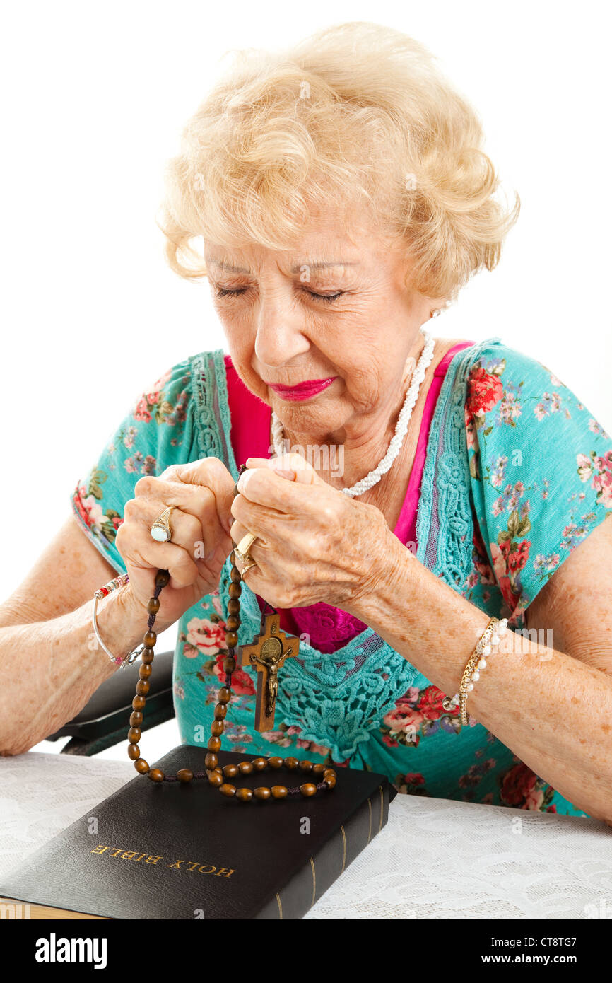 Catholic, Christian elderly woman with her bible, praying the rosary ...