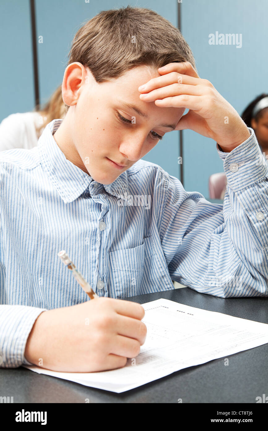 Boy taking test in class. Real person in real-life classroom situation ...