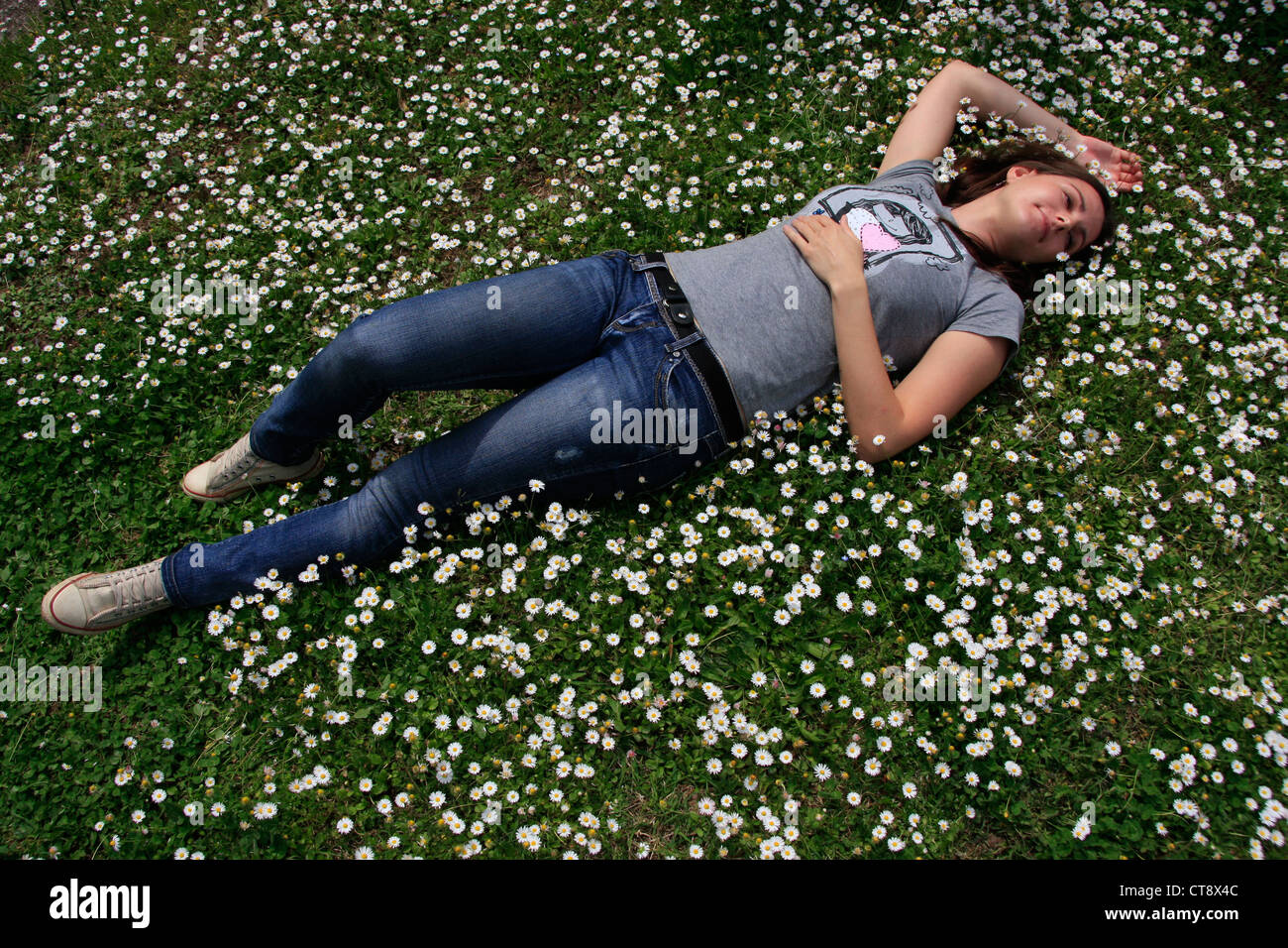 Woman laying flowers hi-res stock photography and images - Alamy