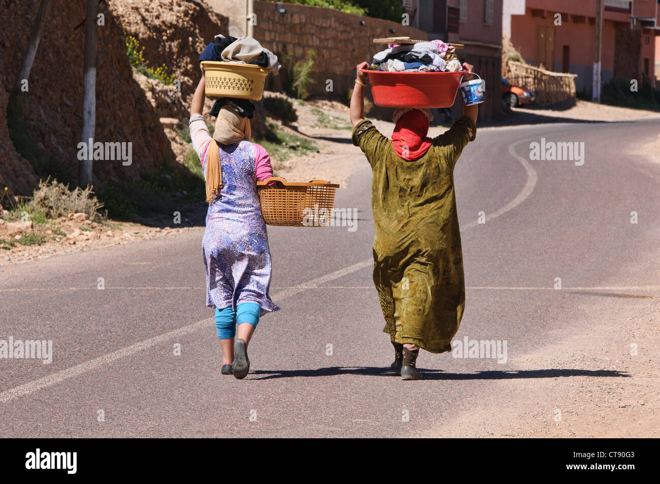 Berber women carrying their laundry in the Dades Gorge, Morocco Stock ...