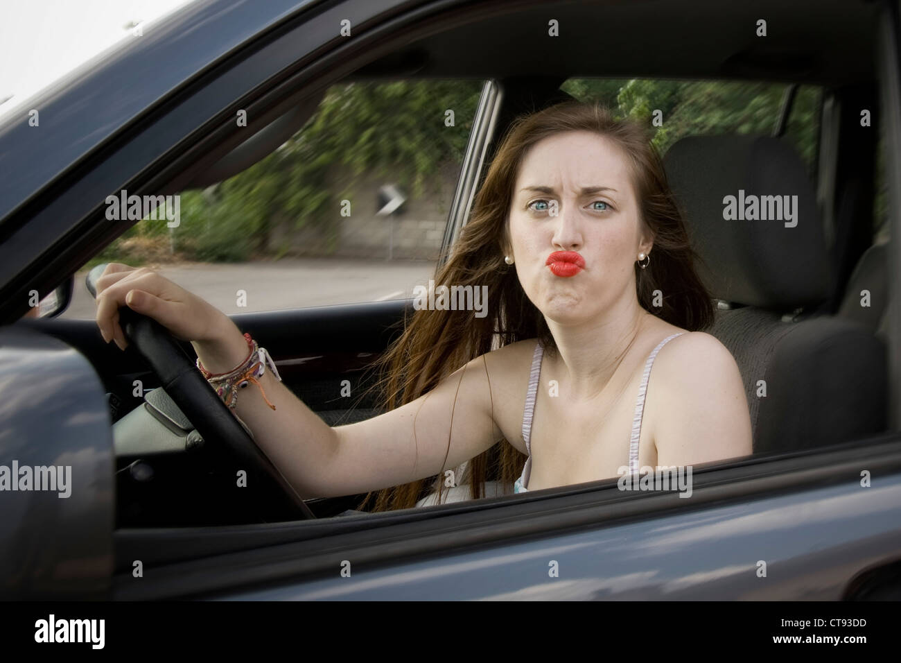 Woman in the car that makes faces Stock Photo - Alamy