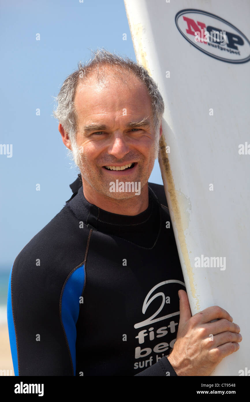 Middle aged Surfer with board on beach at Newquay Stock Photo - Alamy