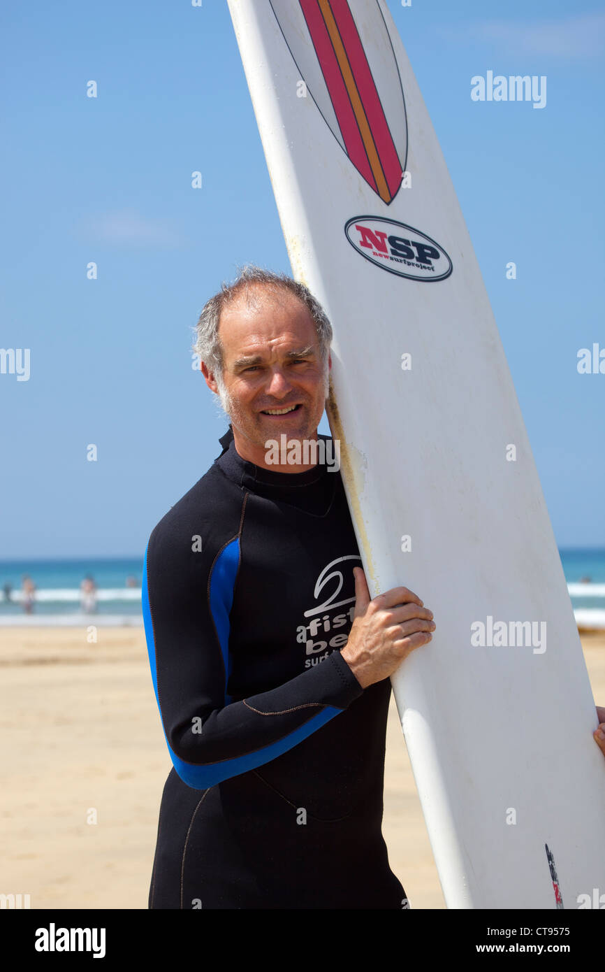 Middle aged Surfer with board on beach at Newquay Stock Photo - Alamy
