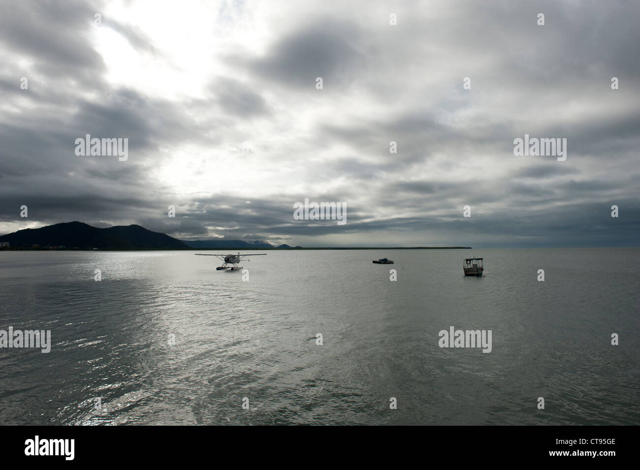 Seaplane and fishing boat moored in the Coral Sea's Cairns bay at ...