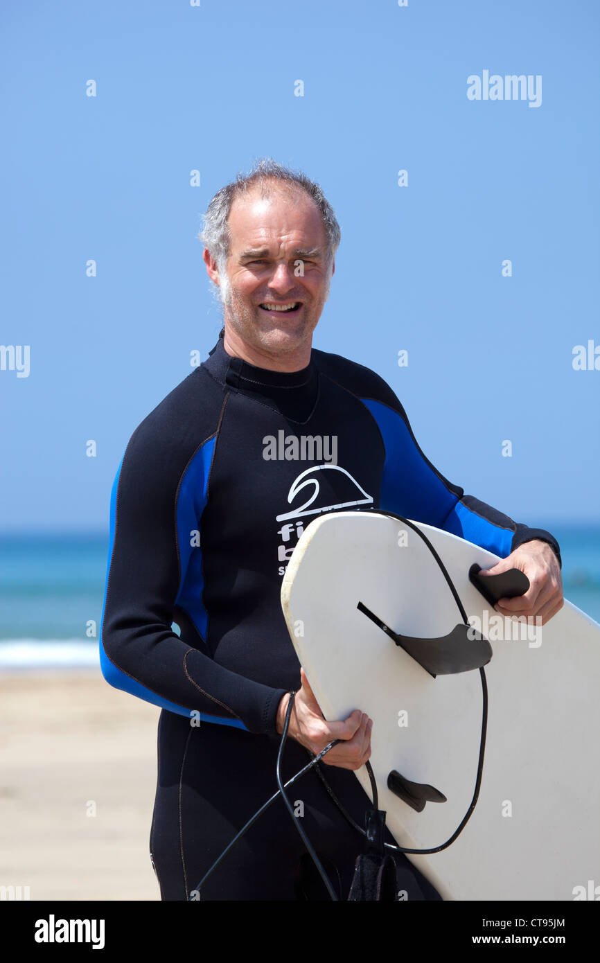 Middle aged Surfer with board on beach at Newquay Stock Photo - Alamy