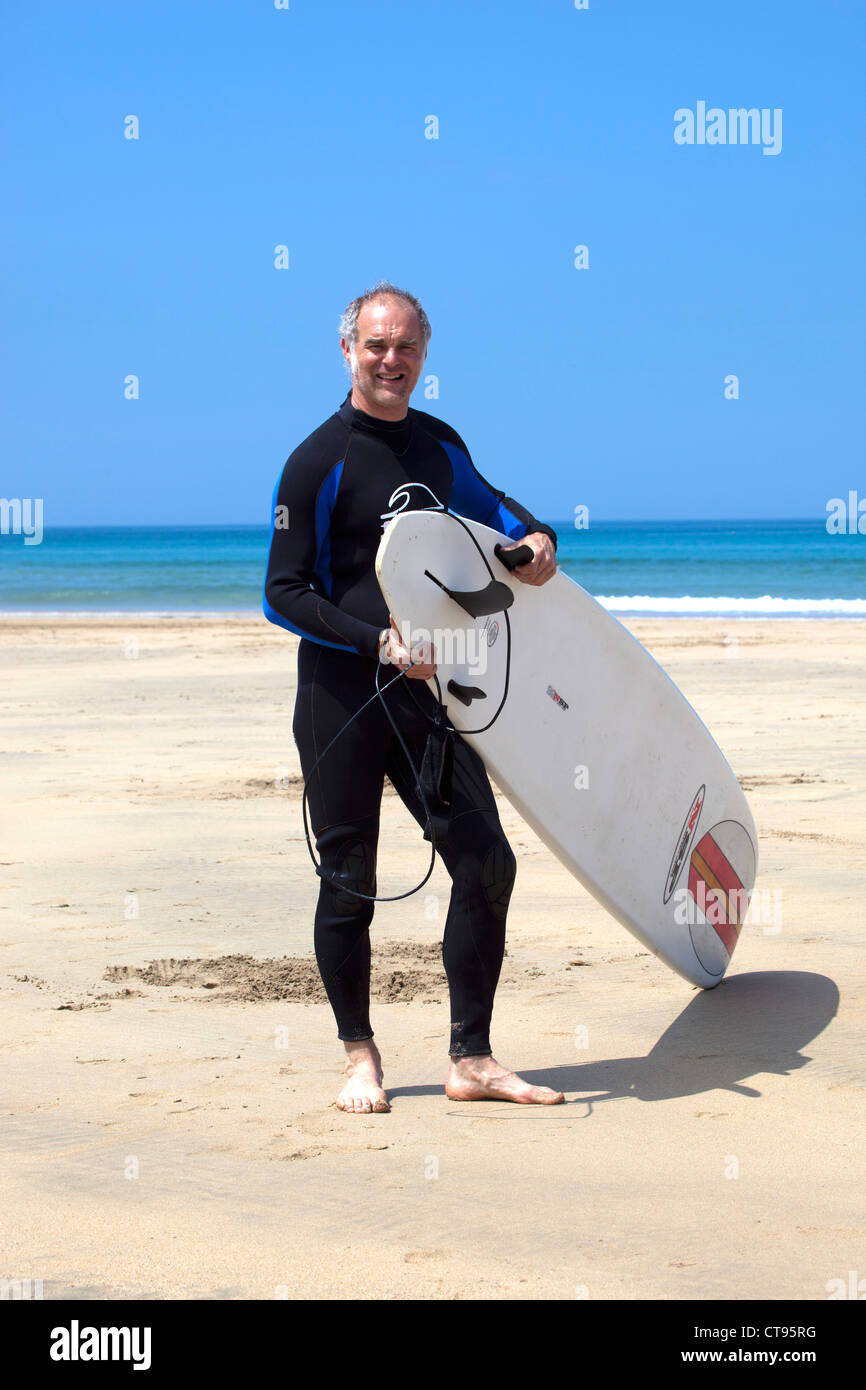 Middle aged Surfer with board on beach at Newquay Stock Photo - Alamy