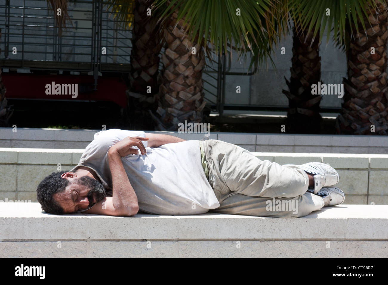 Homeless Man Sleeping On Sidewalk High Resolution Stock Photography and ...