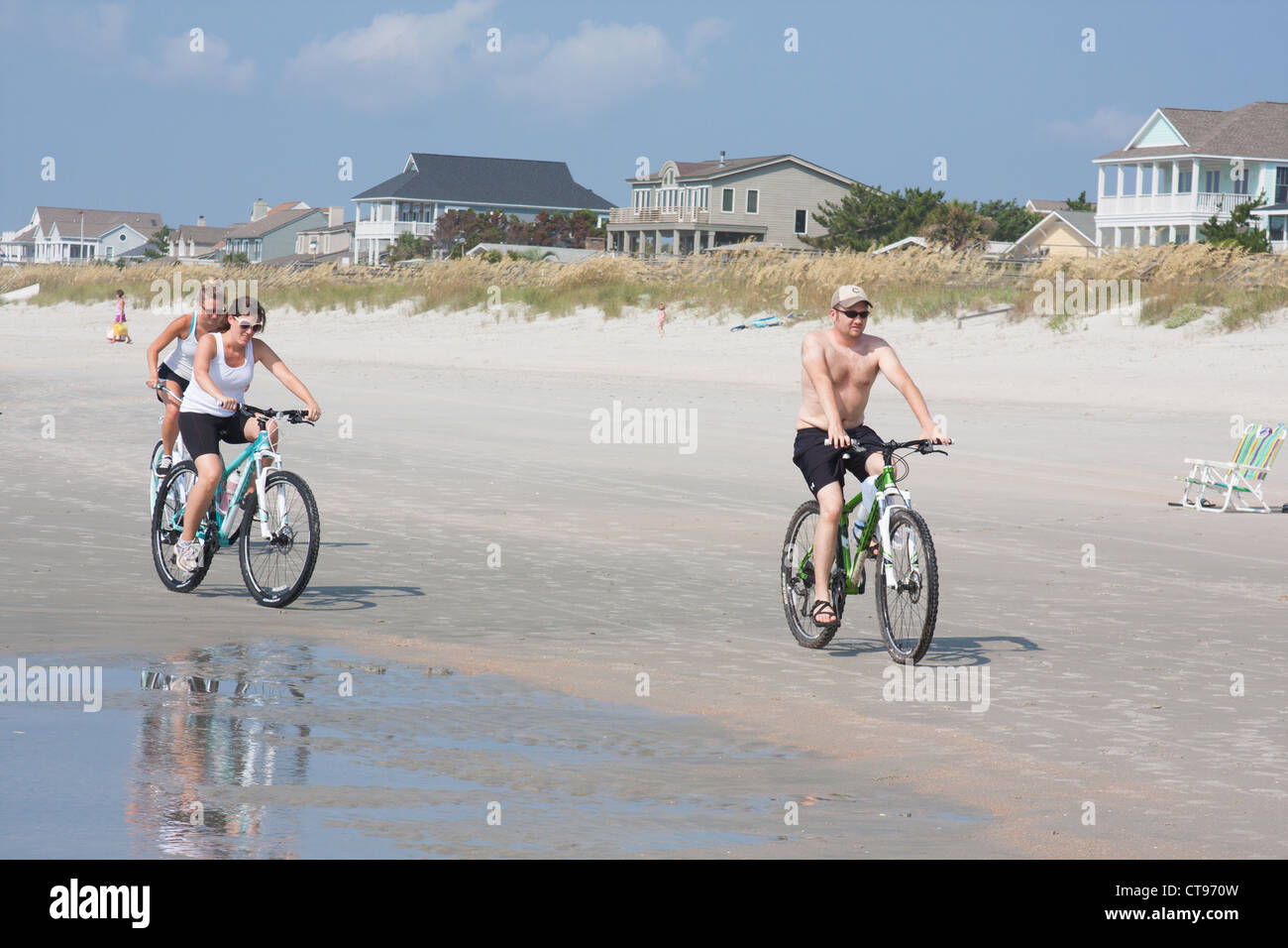 Cyclists Riding On The Beach Stock Photo - Alamy