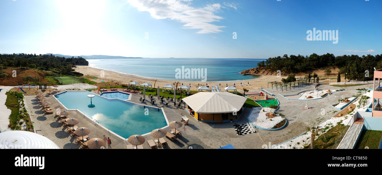 Panorama of swimming pools and bar by a beach at the luxury hotel ...