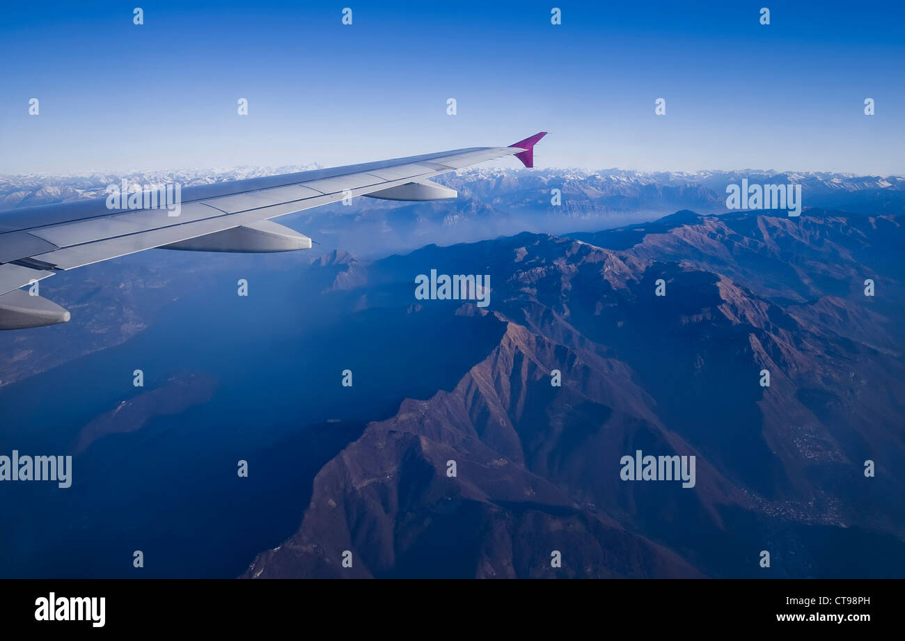 jet plane wing and Italy Alps view Stock Photo - Alamy