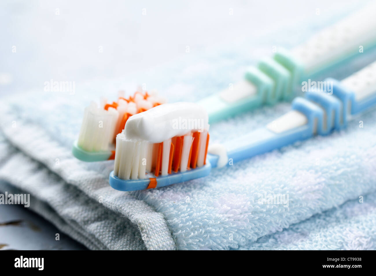 Couple toothbrushes with toothpaste on a towel Stock Photo - Alamy