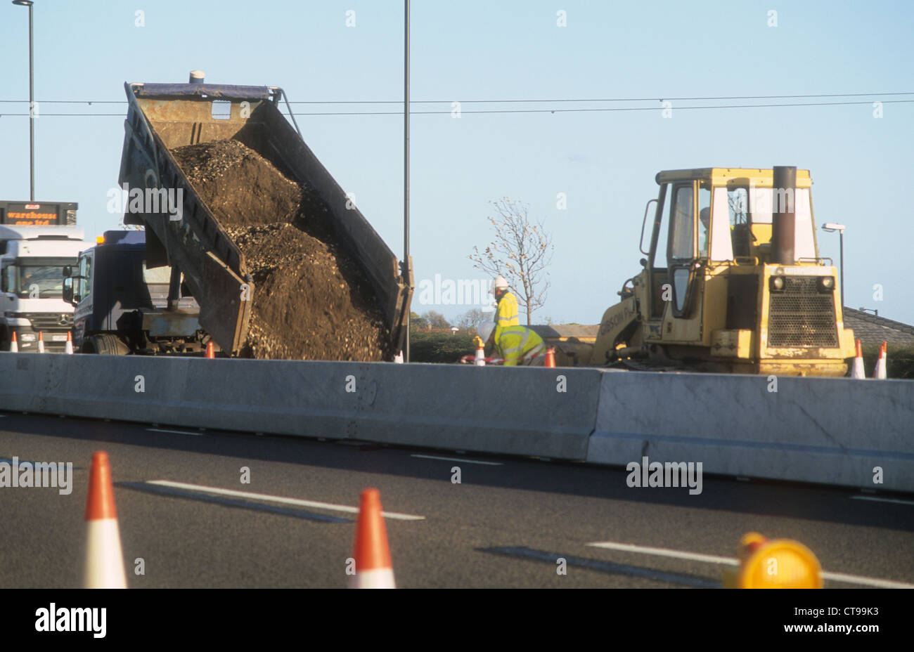Articulated Dumper Truck unloading bitumen to re-surface a major ...