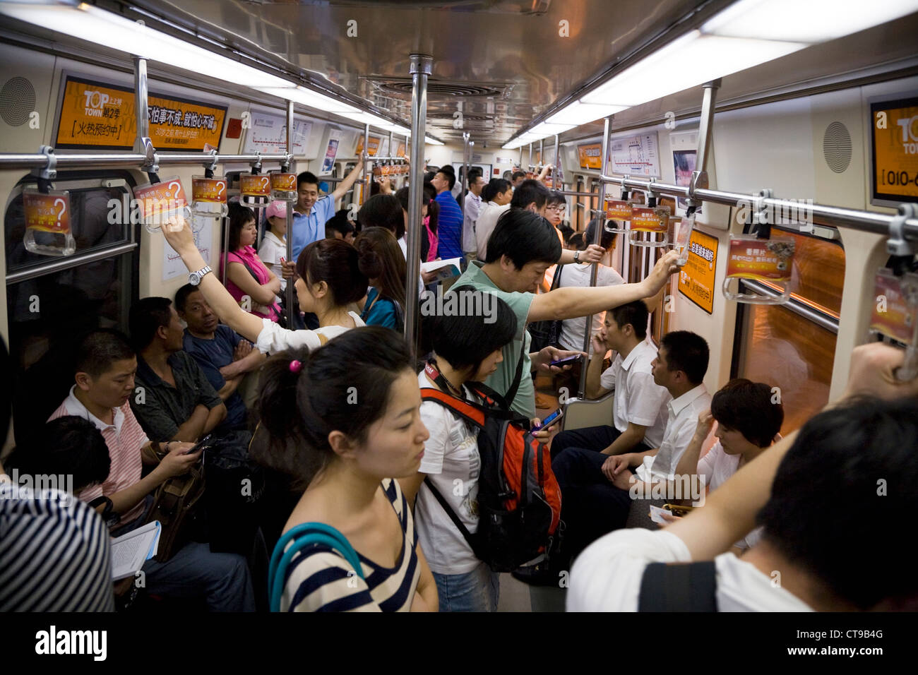 Inside subway tube train carriage compartment with Chinese commuters ...