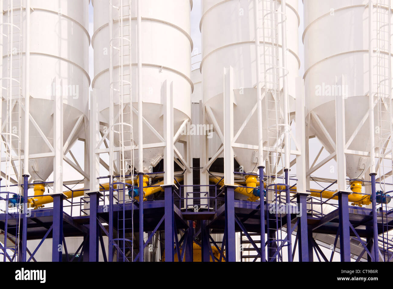 Front shot of four Industrial chemical processing Tanks Stock Photo - Alamy