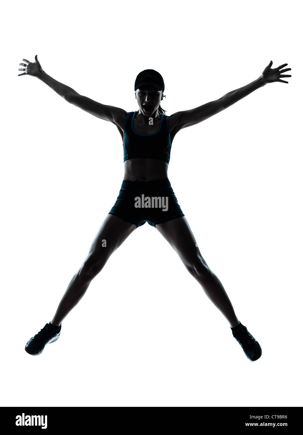 one caucasian woman runner jogger jumping happy jumping in silhouette ...