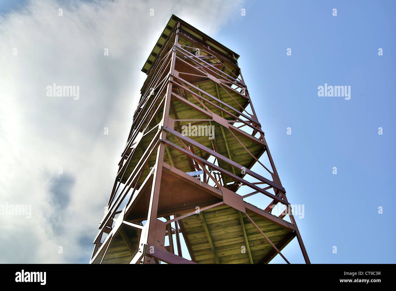 Rusty tower rising over ground under blue sky Stock Photo - Alamy