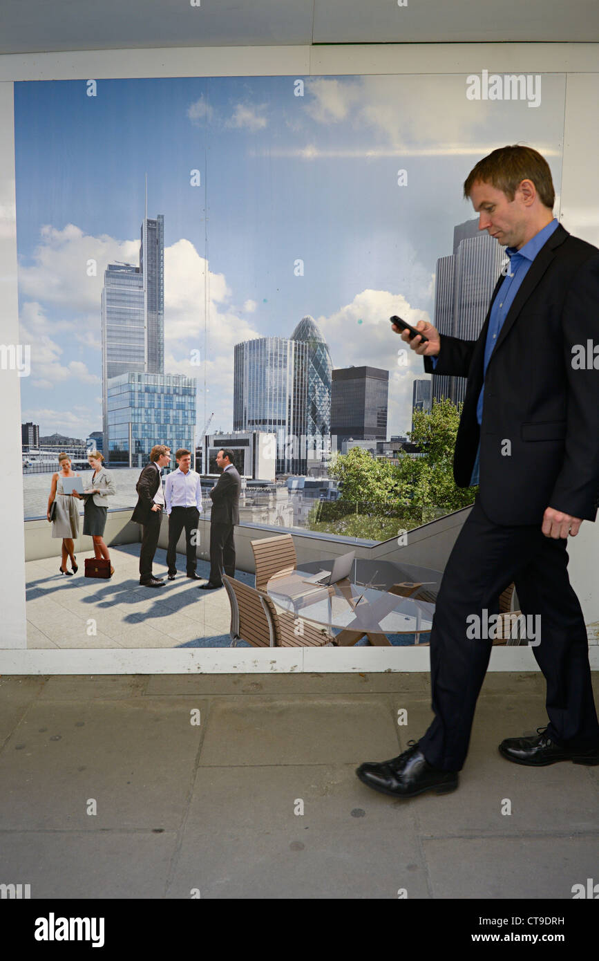 man walks past poster of city of london skyline Stock Photo - Alamy
