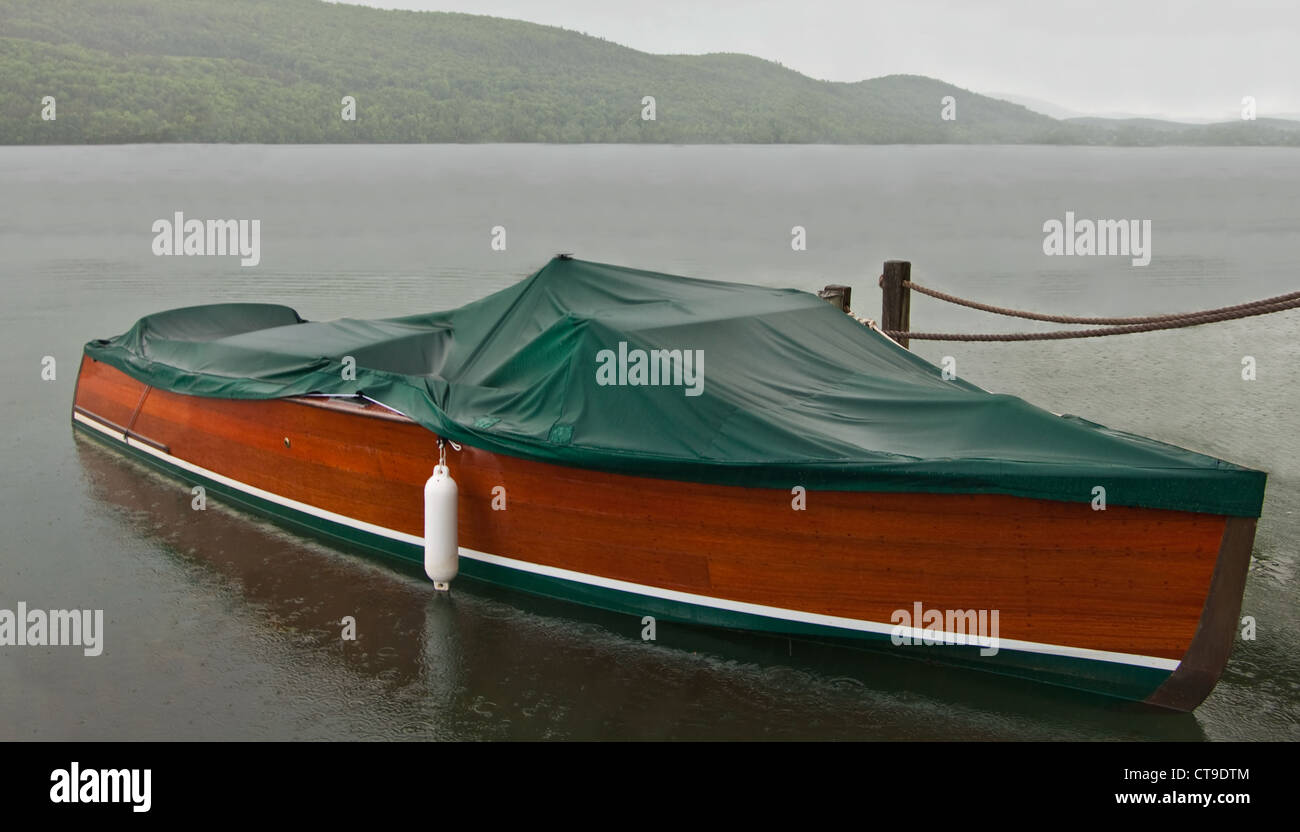 Covered Boat in the Rain Stock Photo - Alamy