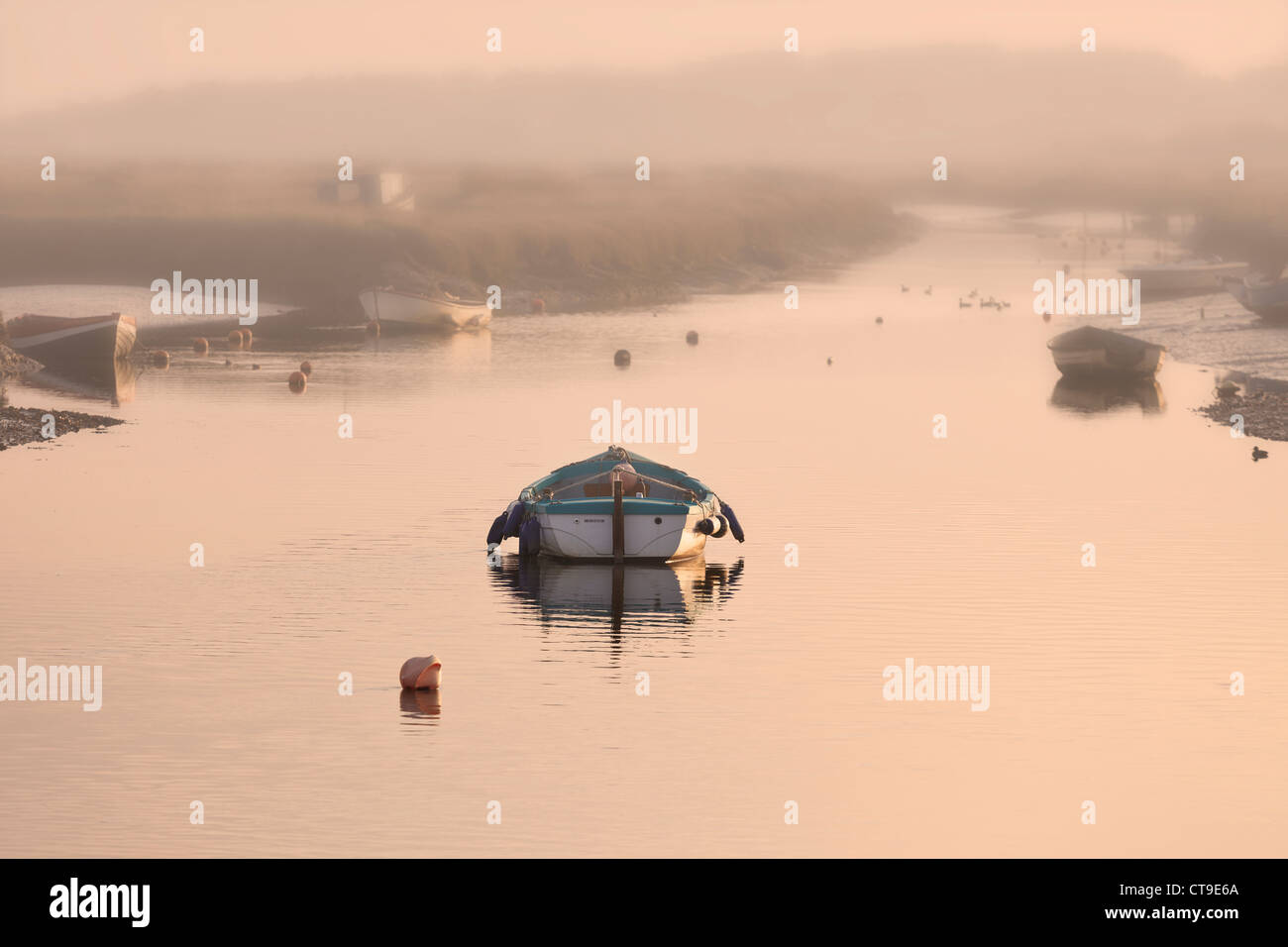 Early morning mist at sunrise over the sea inlet at "Morston Quay ...