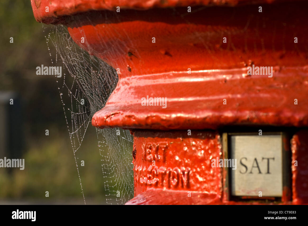 Spider web on a red pillar post box in South West London Stock Photo ...