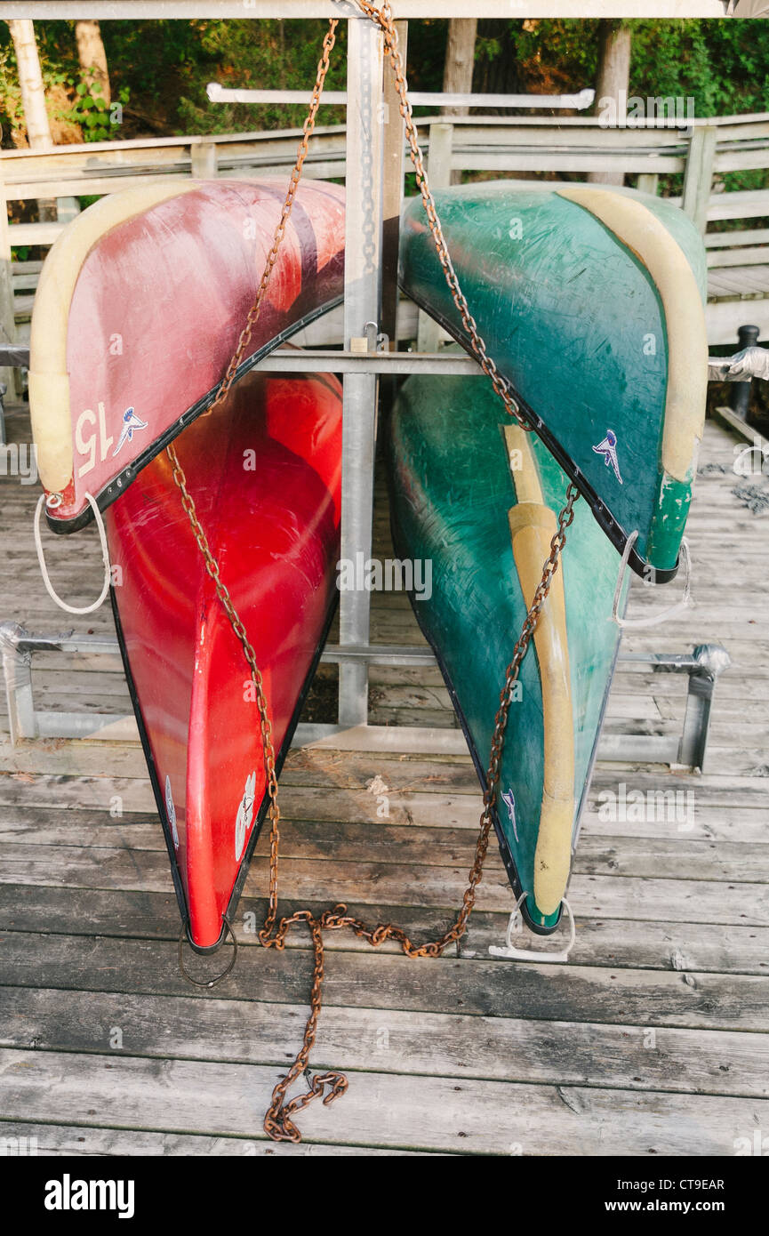 Colorful canoes on dock Stock Photo - Alamy