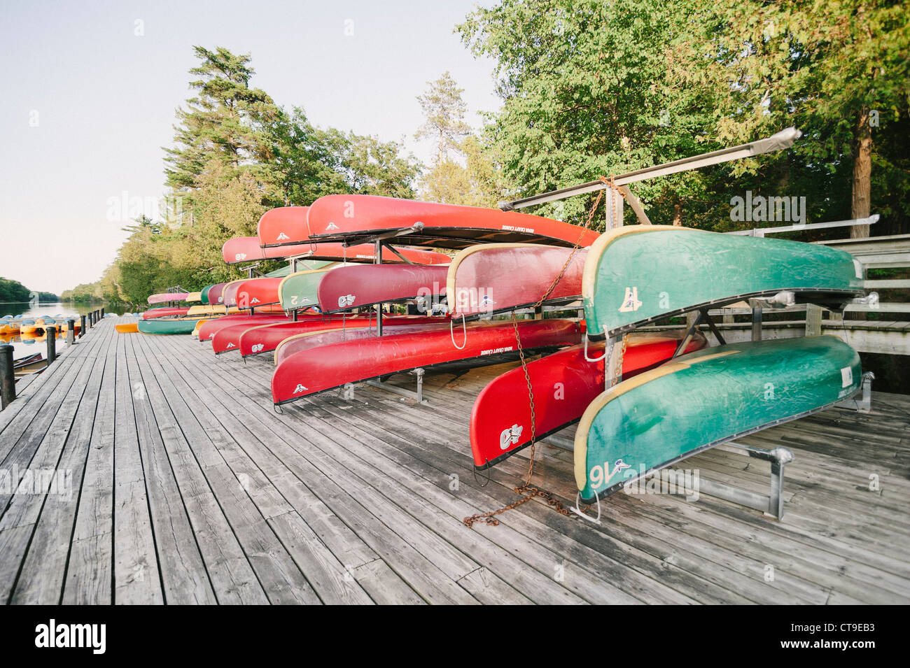 Colorful canoes on dock Stock Photo - Alamy