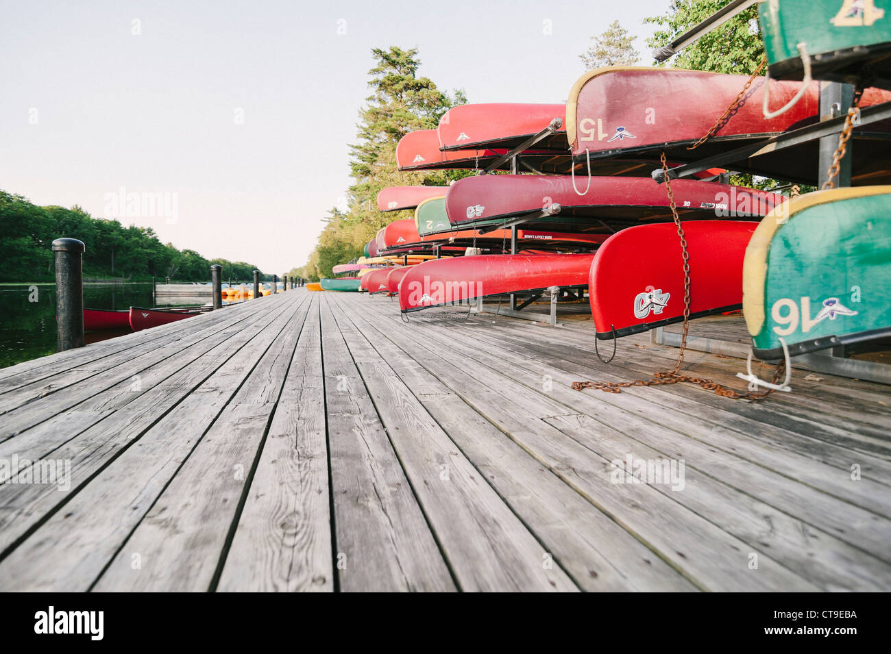Colorful canoes on dock Stock Photo - Alamy