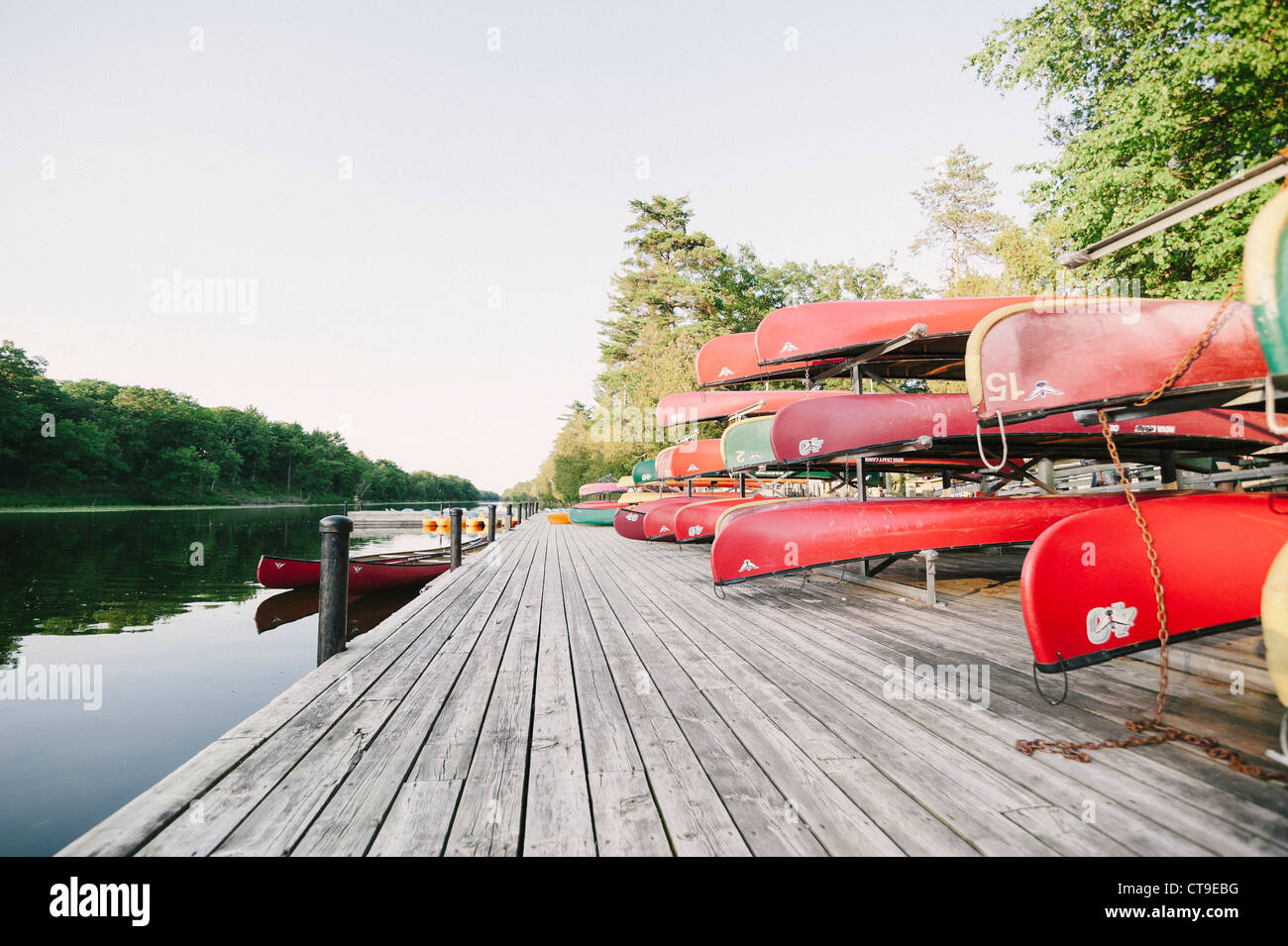 Colorful canoes on dock Stock Photo - Alamy