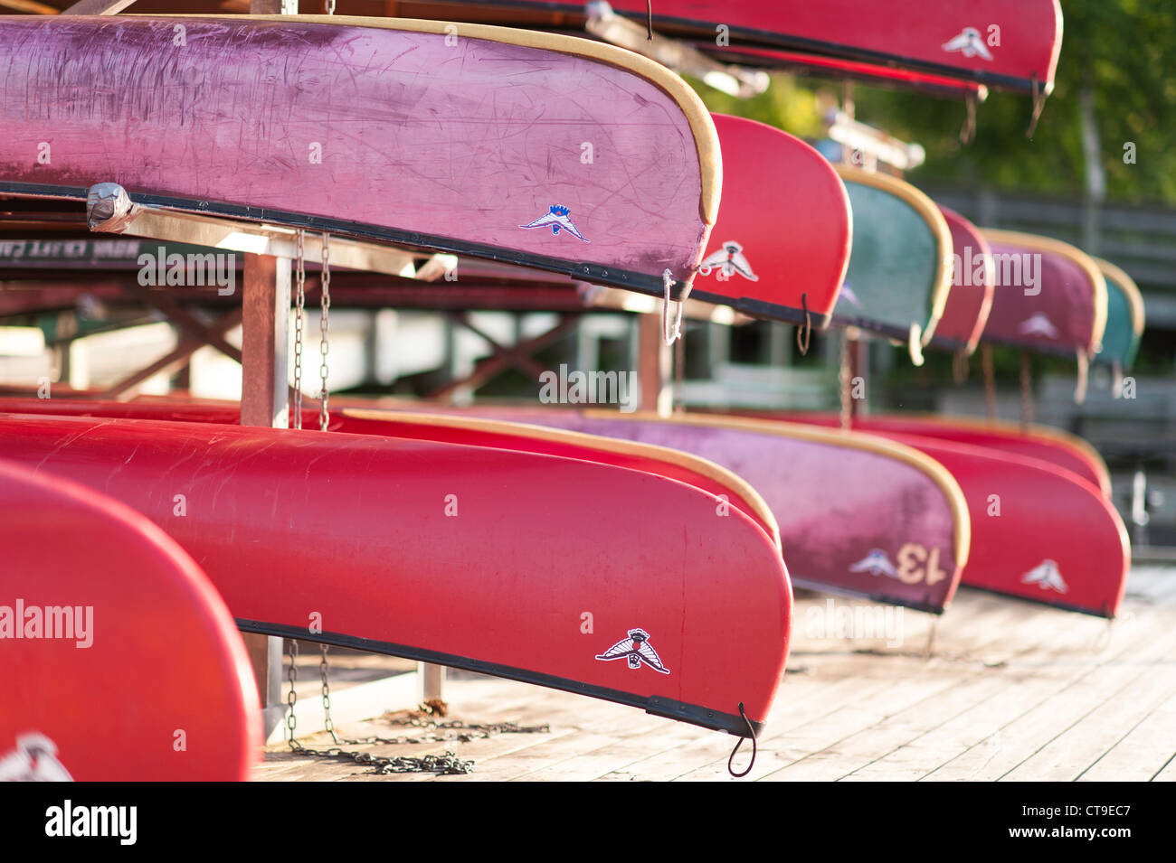 Colorful canoes on dock Stock Photo - Alamy