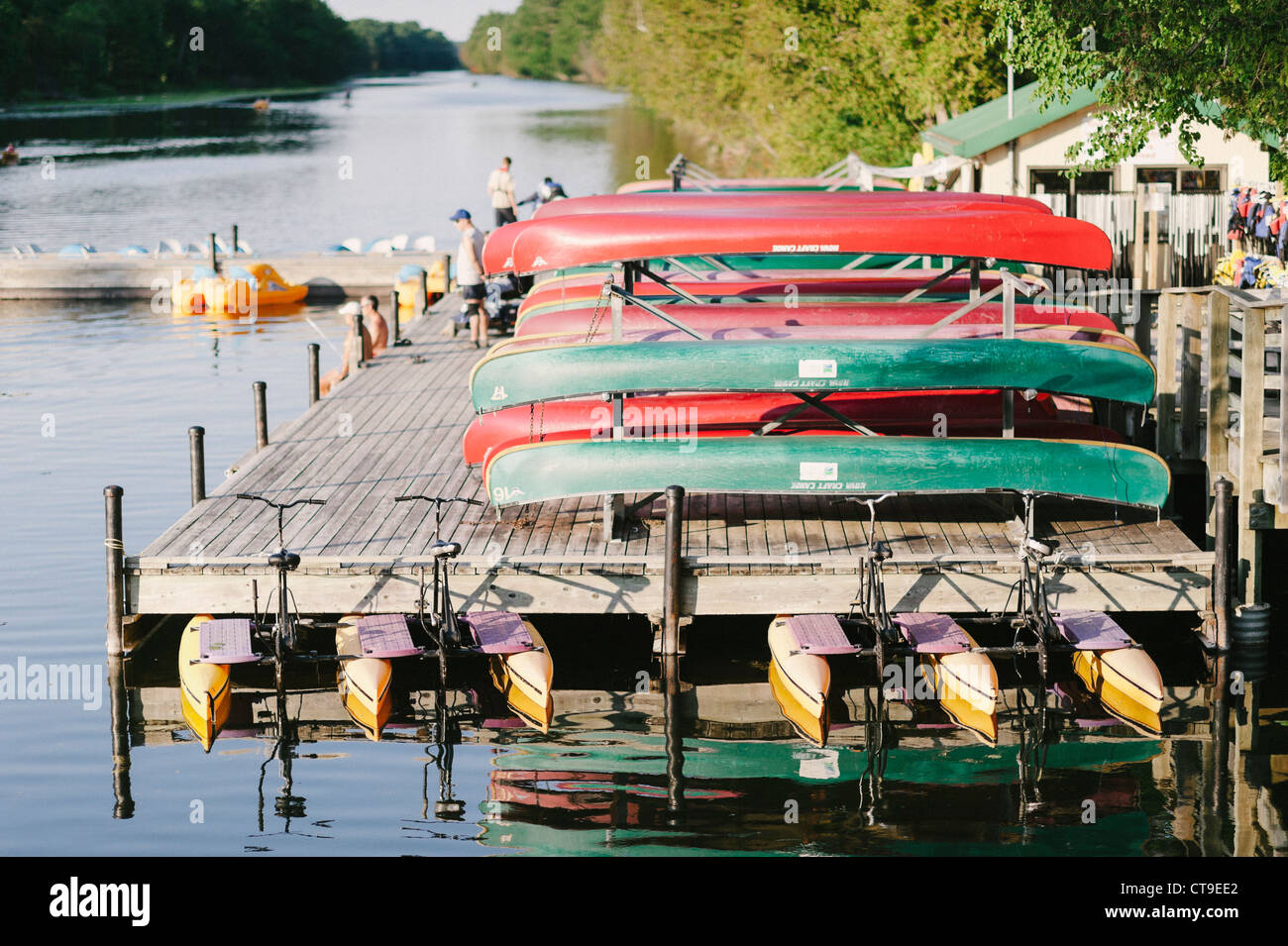 Colorful canoes on dock Stock Photo - Alamy