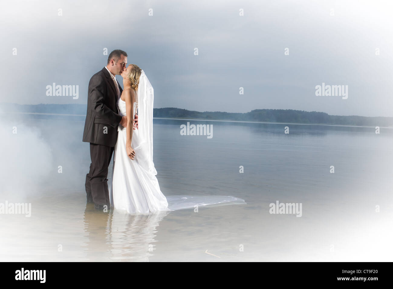 Young couple kissing by the lake Stock Photo - Alamy