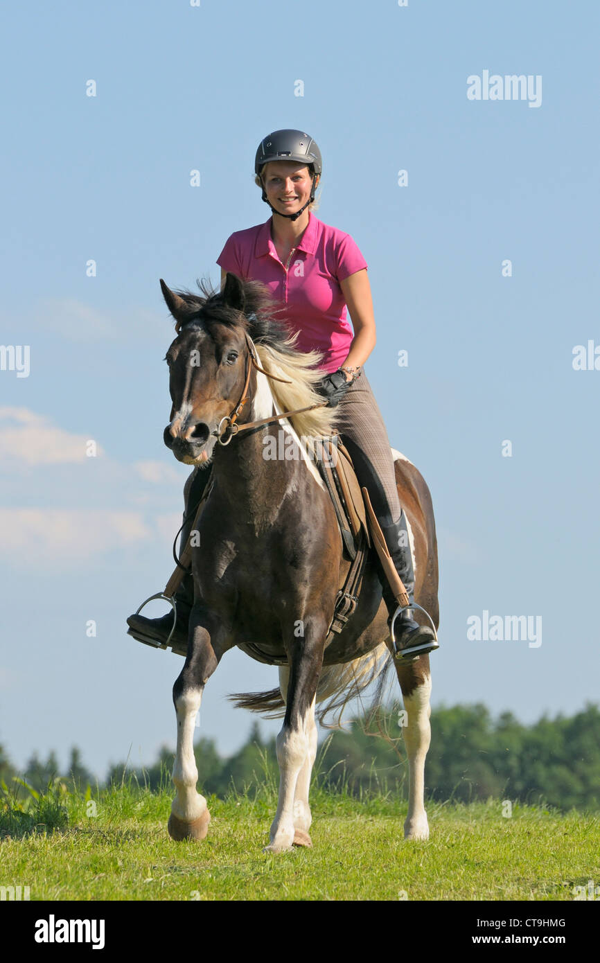 Young rider on back of a Lewitz pony galloping during a ride out Stock ...