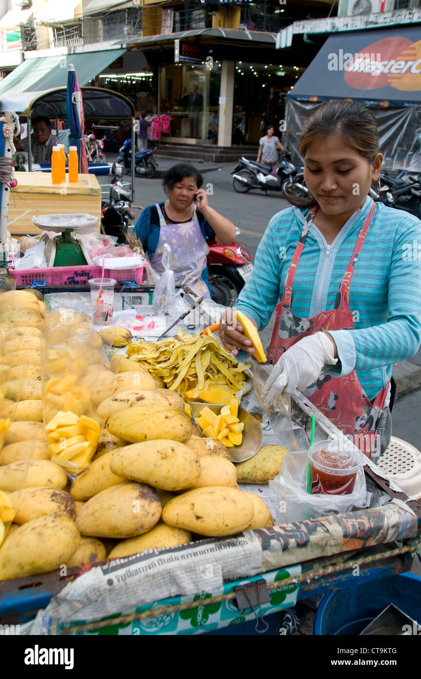 A stall holder selling mangos in a side street in Bangkok, Thailand ...