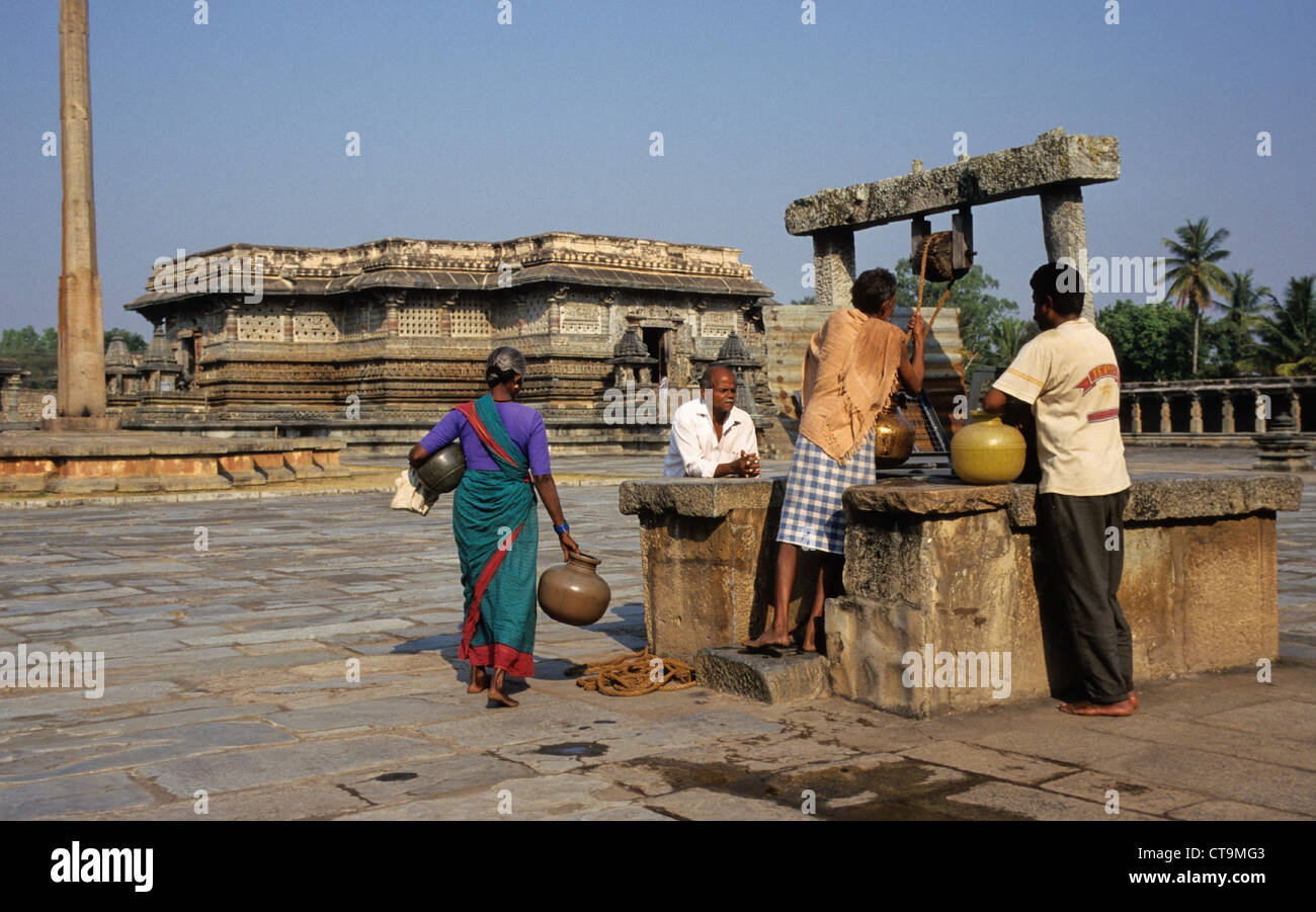 Indians get water from a temple well Stock Photo - Alamy